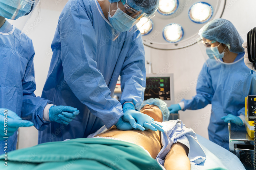 Medical team in Surgical gown help patient to making CPR Cardio ...