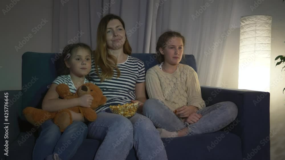 Video „Happy family watching TV at home. Mom and kids are watching tv ...
