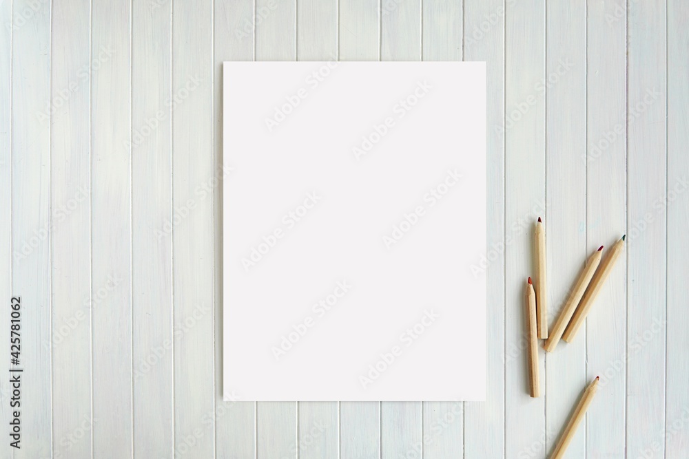 Blank vertical paper sheet and pencils on wooden background, US letter ...