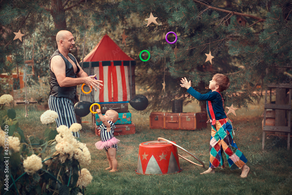 Family portrait in vintage circus style. Father is dressed as a ...