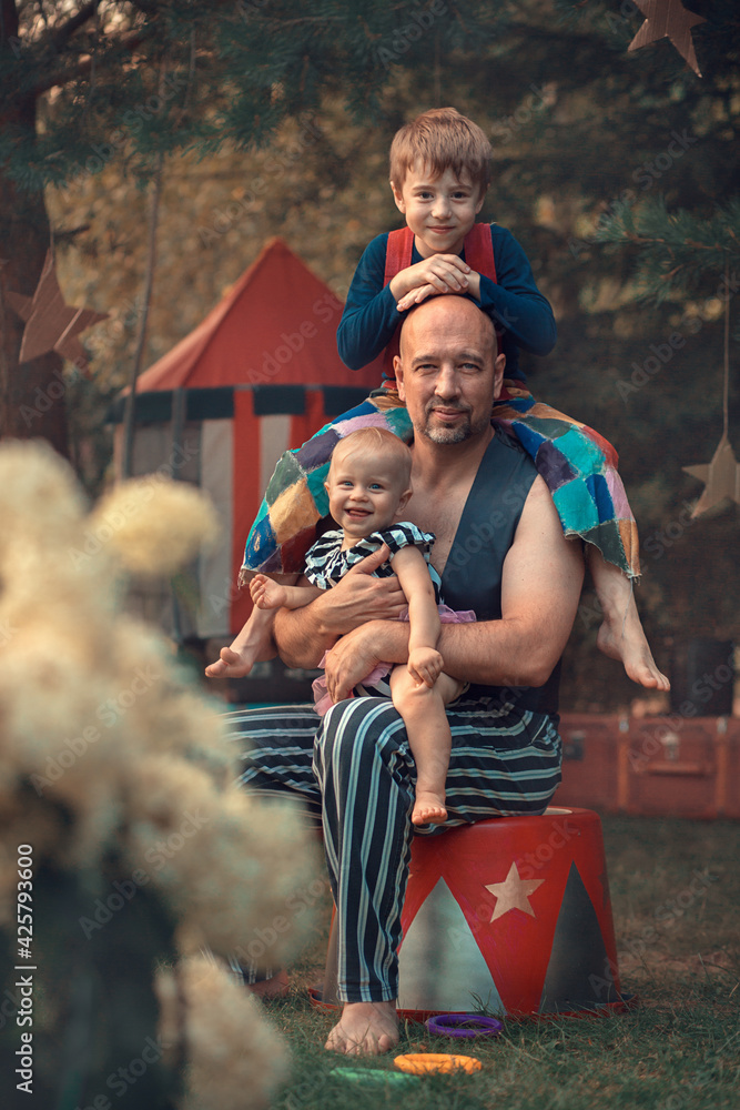 Family portrait in vintage circus style. Father is dressed as a ...