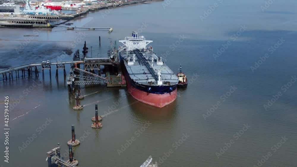 Crude oil tanker ship loading at refinery harbour terminal aerial ...