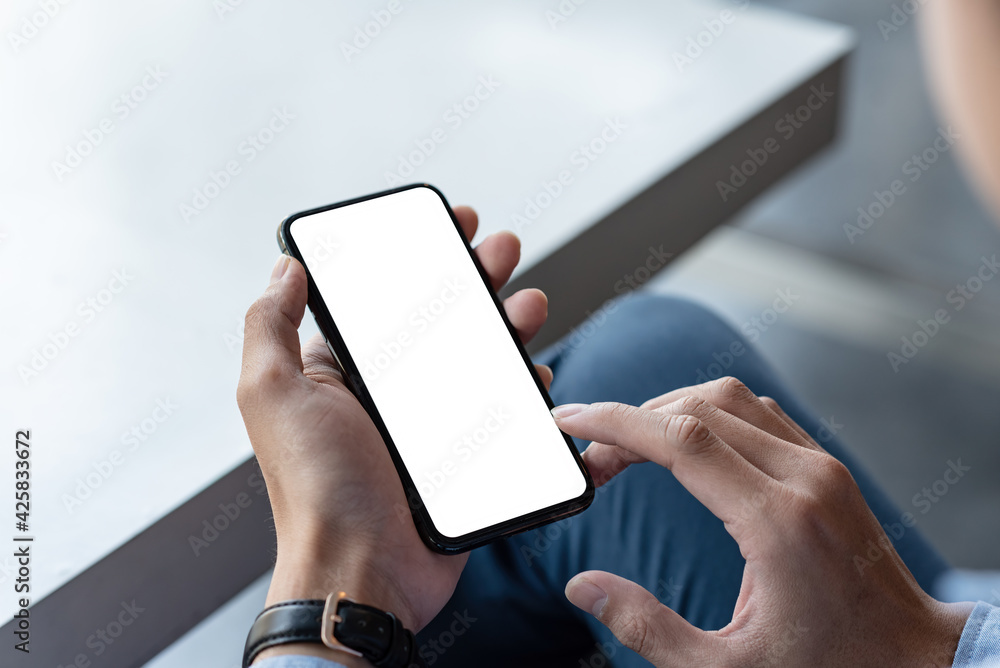 Close-up of a man hand holding a smartphone with a blank white screen ...