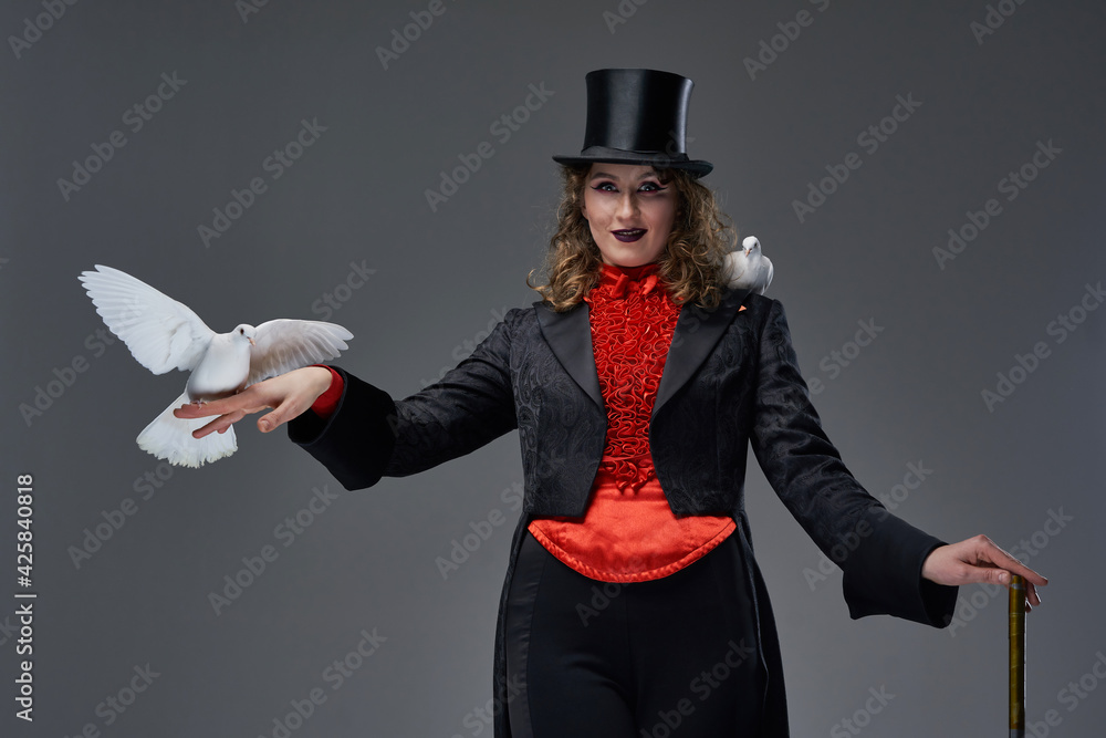 Beautiful woman from circus showing tricks with stick and doves Stock ...