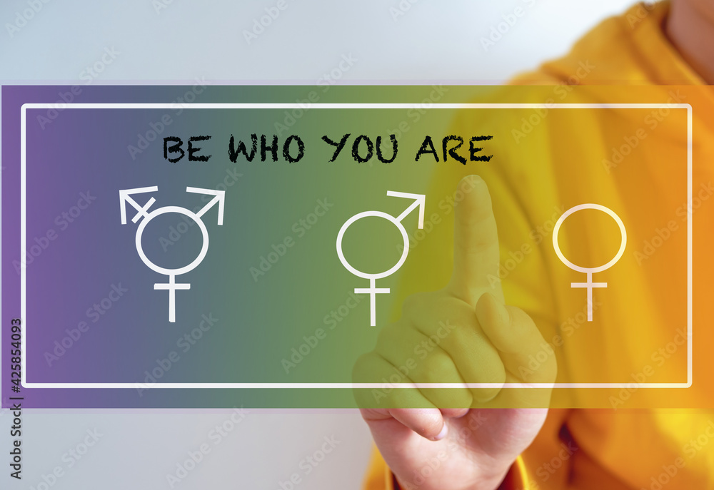 Gender confusion in teenager boy. A teenage boy pointing at the gender ...