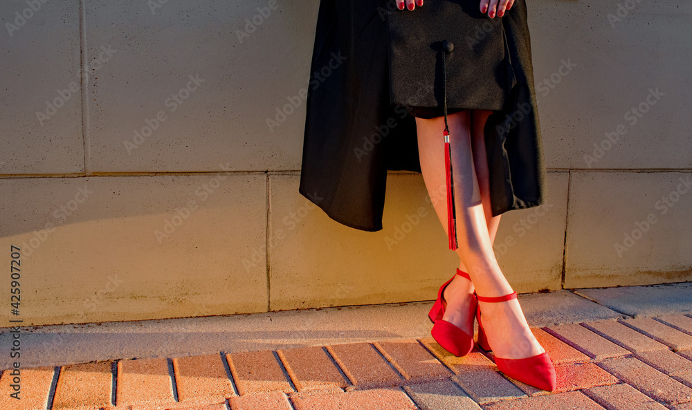 Young Woman in Red Shoes Holding Graduation Cap with Tassel and Wearing ...