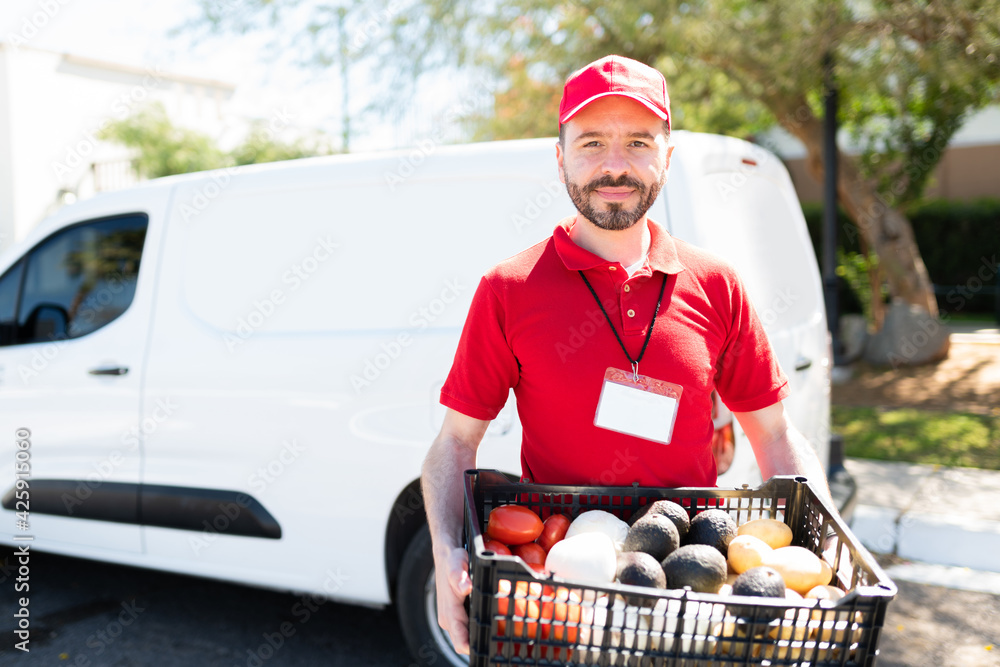 Smiling driver working as a delivery person for a market Stock Photo ...