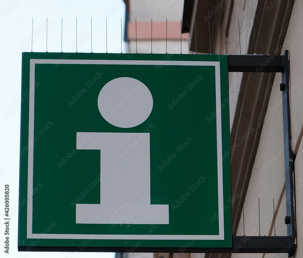 Tourist information sign, green logo with letter i in the street ...
