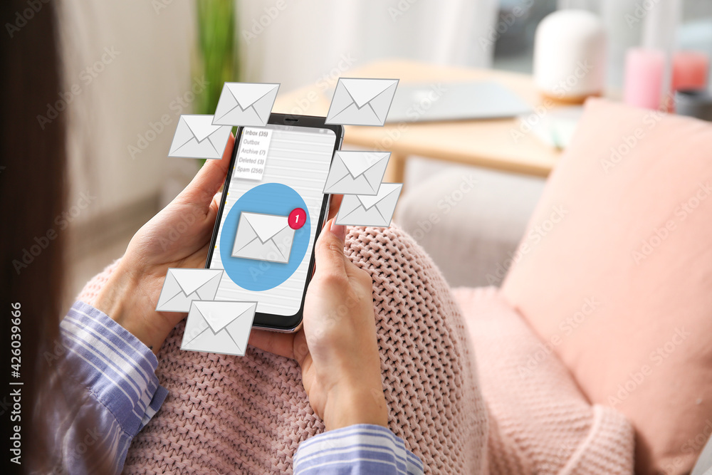 Woman using mobile phone to check an email at home Stock Photo | Adobe ...