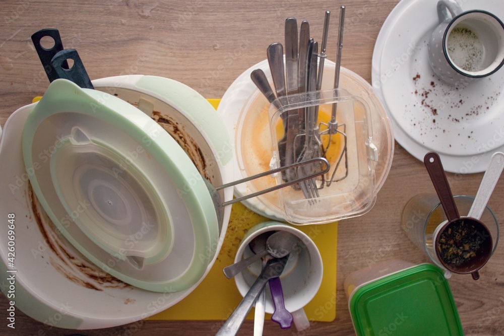 Dirty dishes stacked on the kitchen counter waiting to be washed ...