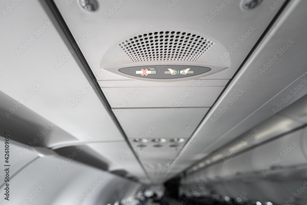 "Fasten seatbelt" and "No smoking" lighting icon on the overhead board ...