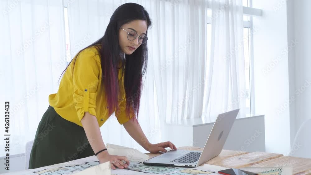 Asian Woman Female Designer Architect Works With Blueprints In Office ...