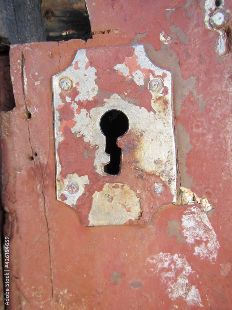 Broken rusty and deteriorated locks on an old wooden door from the 16th ...