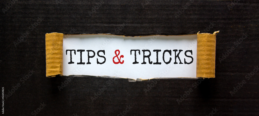 Tips and tricks symbol. Words 'Tips and tricks' appearing behind torn ...