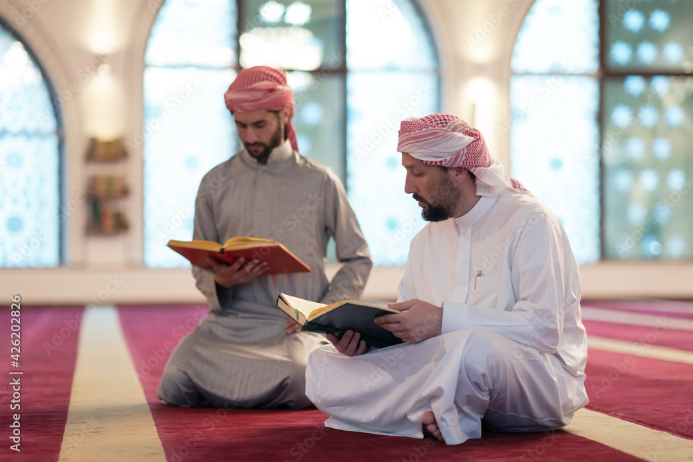 two muslim people in mosque reading quran together concept of islamic ...