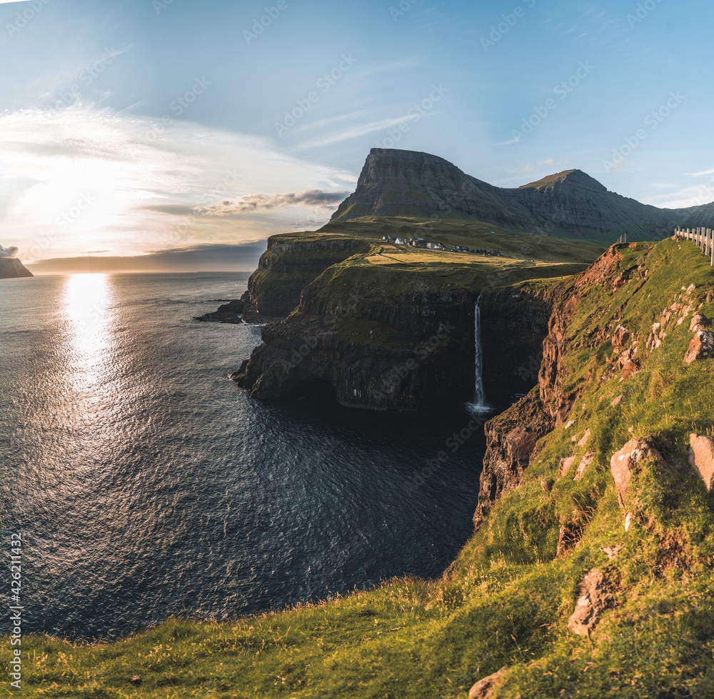 Gasadalur village and Mulafossur its iconic waterfall during summer ...