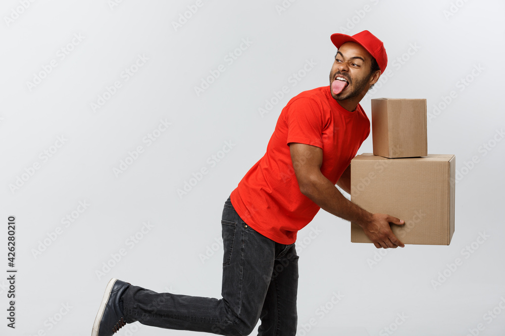 Delivery Concept - Handsome African American delivery man rush running ...