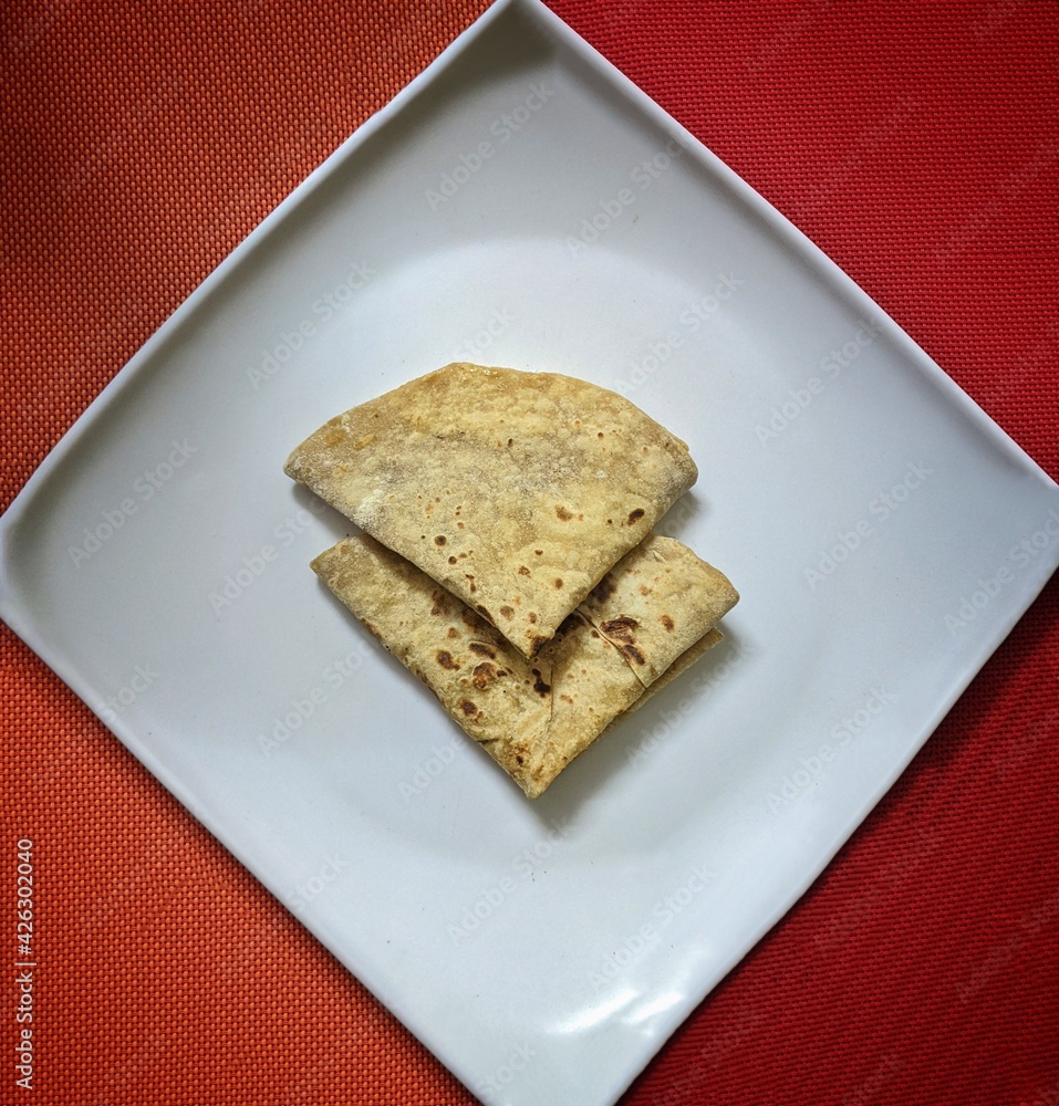 Indian Chapati / fulka/pulka or Gehu Roti on white plate. It's a ...