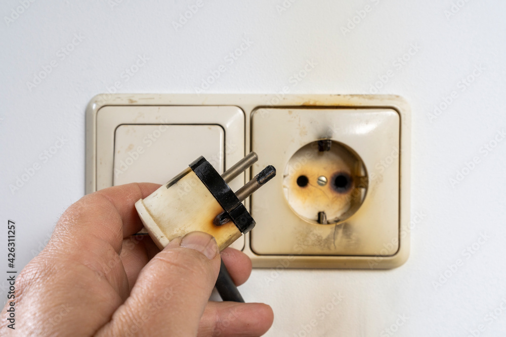 Burned eu style socket in hand. Power Plug after short circuit and ...