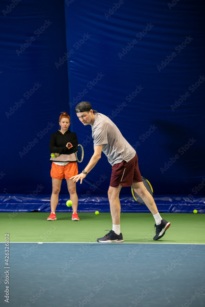 Tennis player getting instruction from coach how to play game on a ...