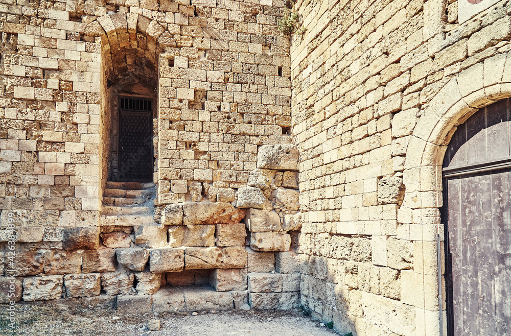 Weathered ancient Rhodes fortress brick and stone wall with empty arch ...