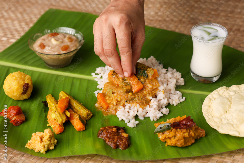 Onam sadhya, Indian women eating with hand boiled rice, served for ...