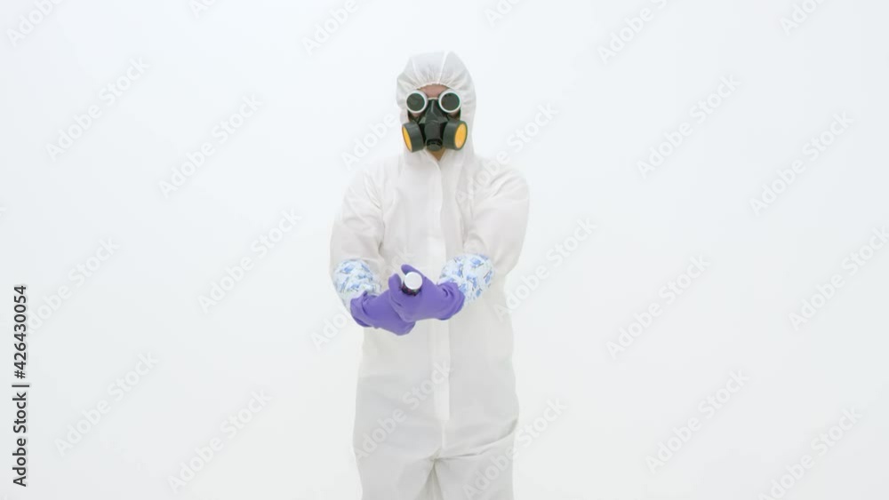 Man in white chemical protection suit and gas mask blows the party ...