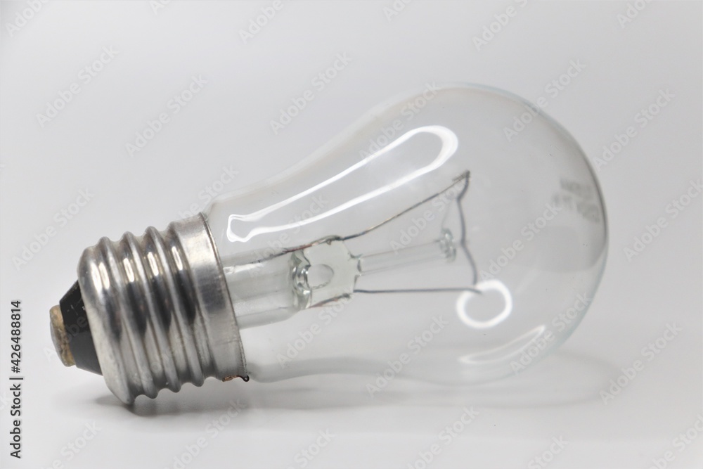 Incandescent light bulb on a white background. Energy-consuming way of ...