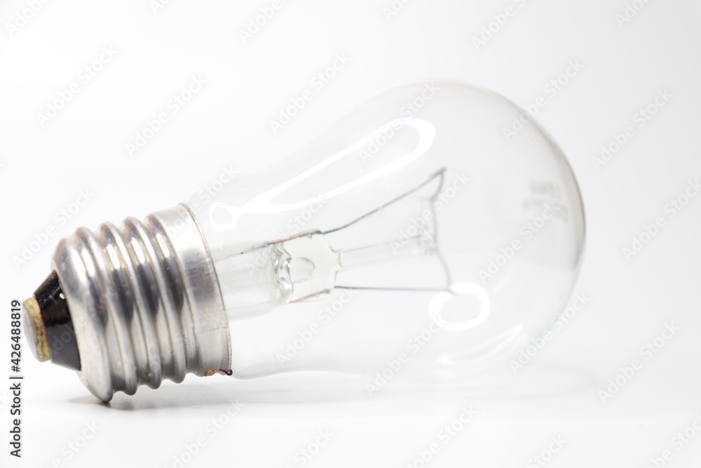 Incandescent light bulb on a white background. Energy-consuming way of ...