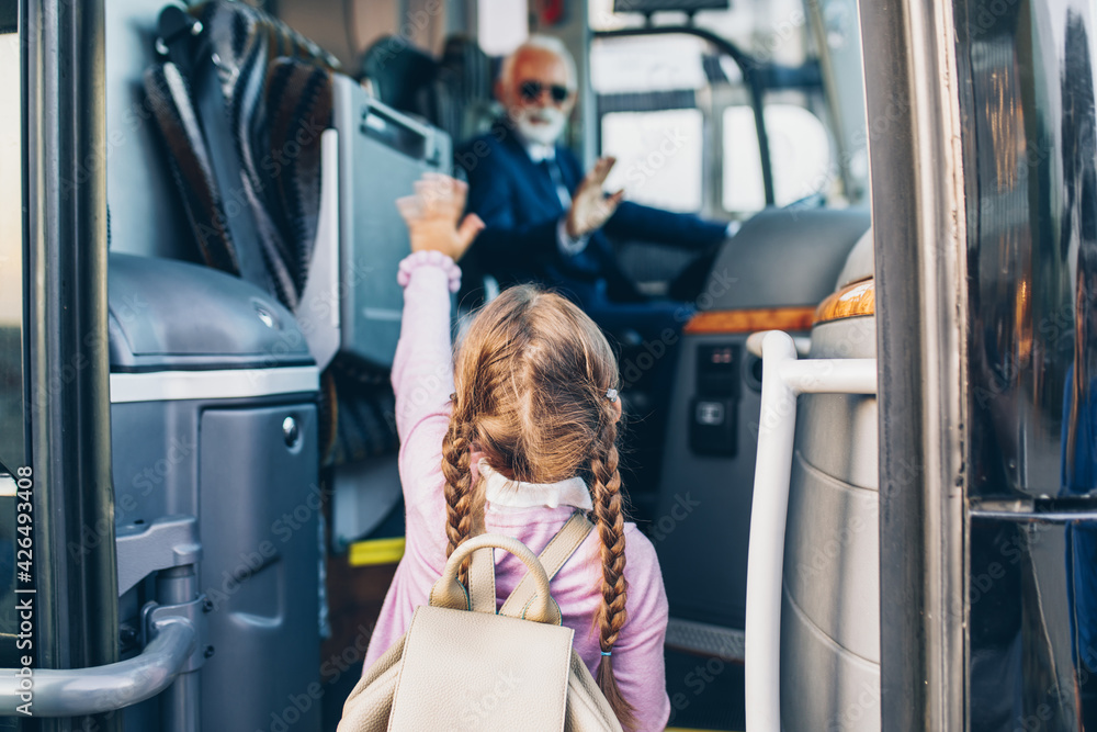 Cute little girl going into the bus. Stock Photo | Adobe Stock