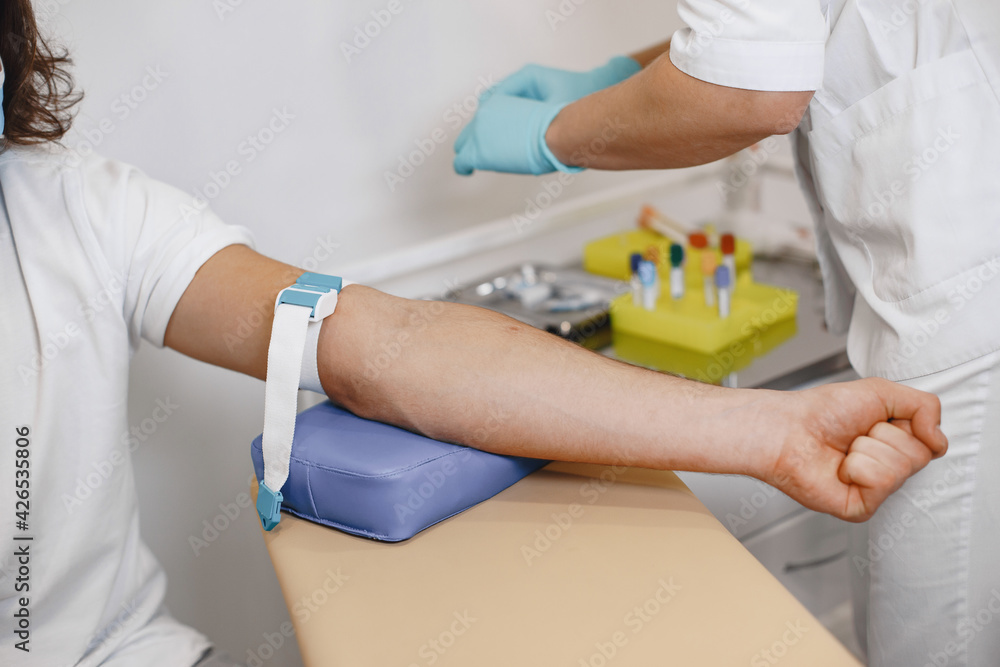 Nurse taking blood sample from patient at the doctors office Stock ...