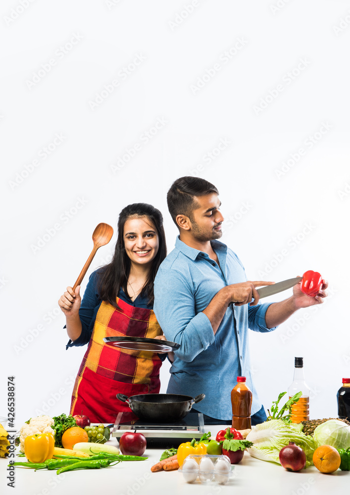 Indian couple cooking - Attractive wife and handsome husband in kitchen ...
