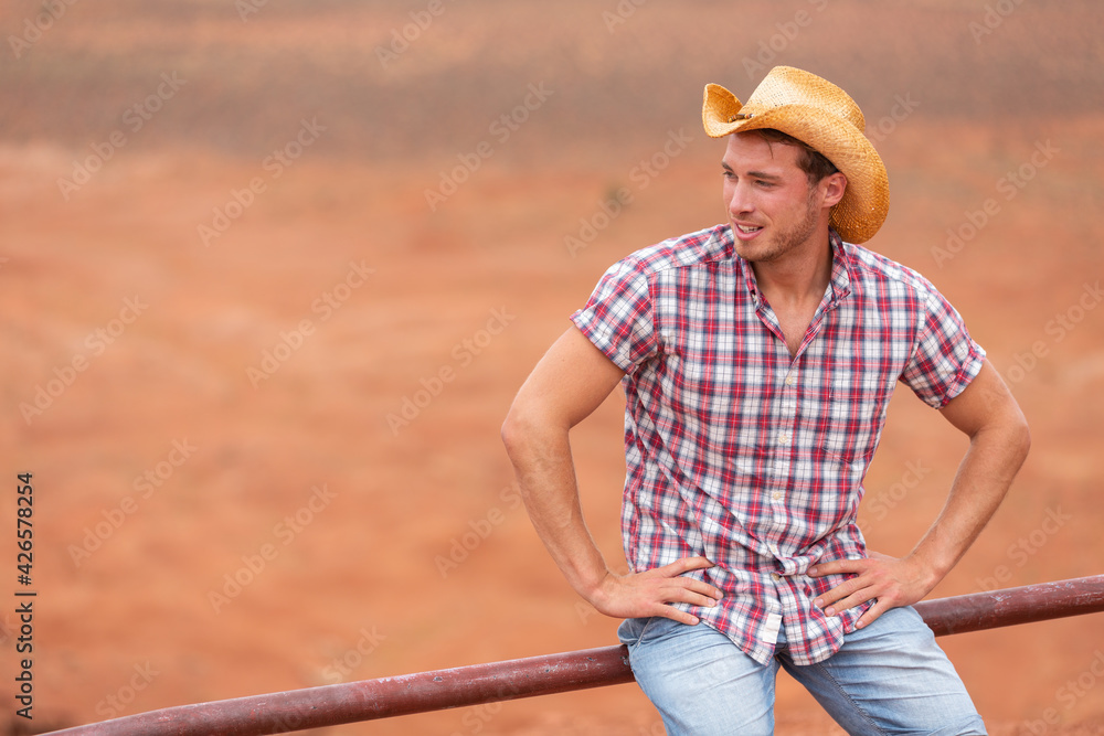 Cowboy farmer man in country side looking away at desert land ...