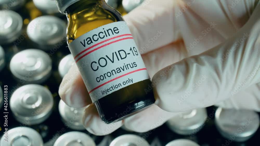 Laboratory researcher hand holding vaccine vial on for global ...