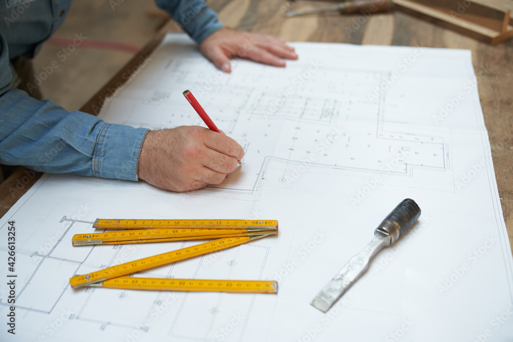 Architect or craftsman drawing a blueprint Stock Photo | Adobe Stock