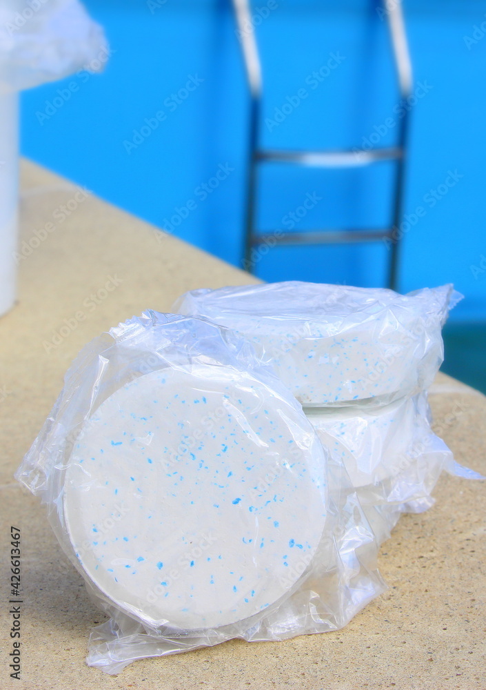 White chlorine tablet in the hand of maintenance personnel for ...