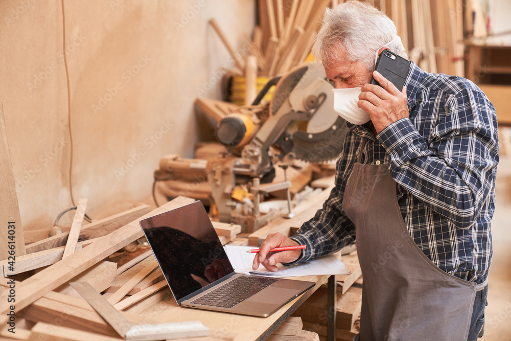 Craftsman with face mask talking to a customer Stock Photo | Adobe Stock