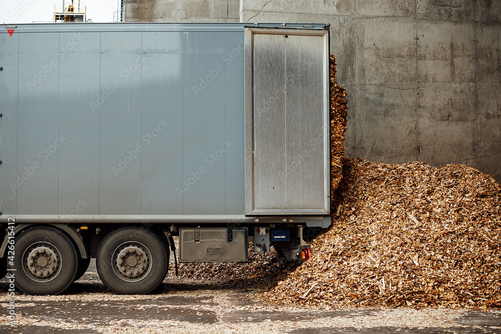 the truck unloads tons of wood waste. sawdust and shavings are stored ...