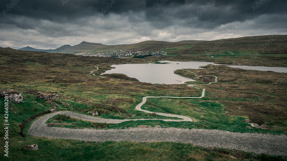 hiking trail around Lake Toftavatn close to village Runavik, dark ...