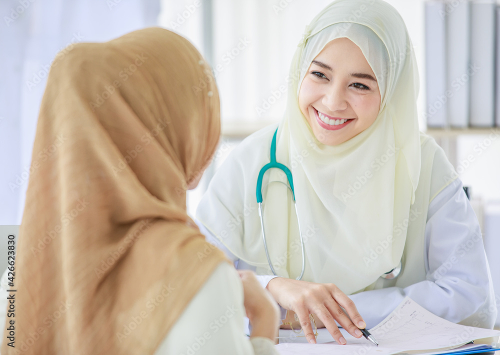Horizontal portrait shot of attractive smiling adult Muslim doctor ...