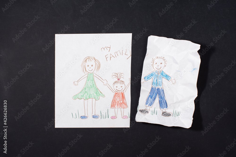 Child's drawing of a family on paper. Mom, dad and baby are holding ...