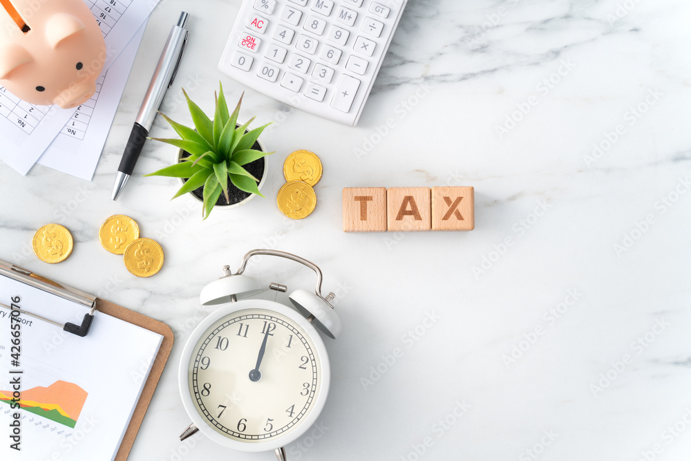Top view of calculating and paying tax concept on marble white table ...