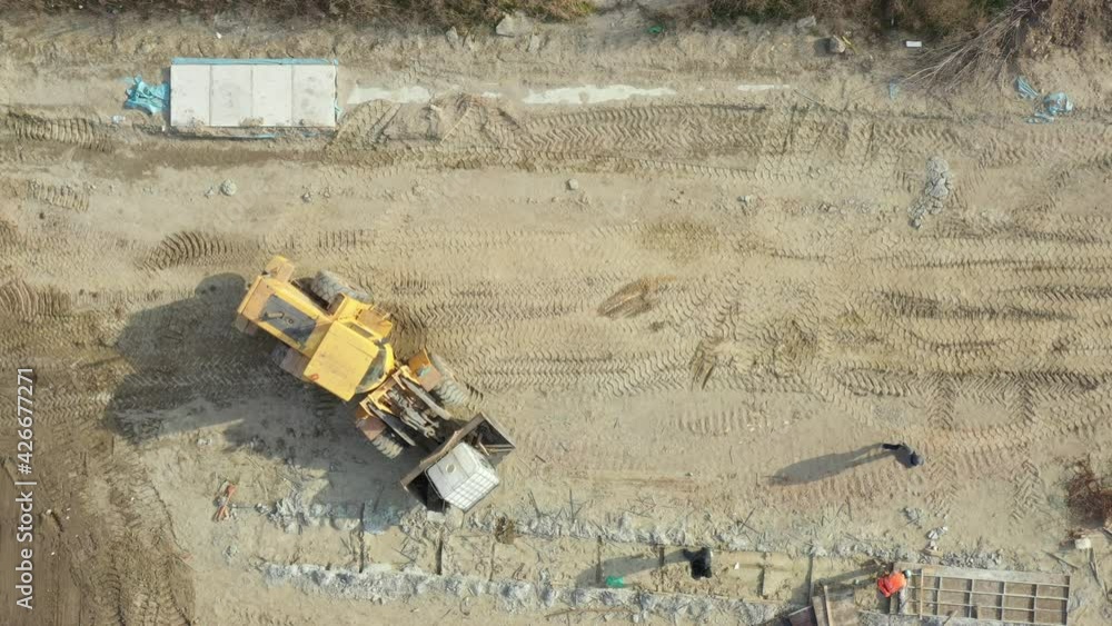 Above top view, overhead, on bulldozer with wheels is carry plastic ...