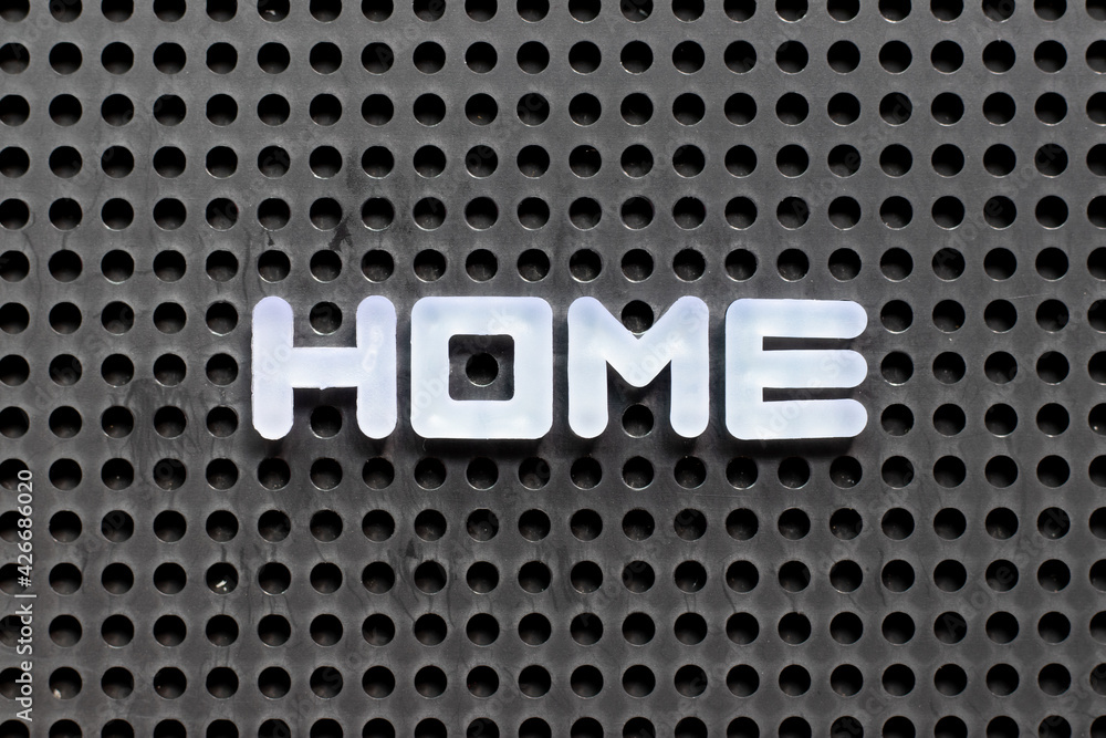 White color letter in word home on black pegboard background Stock ...