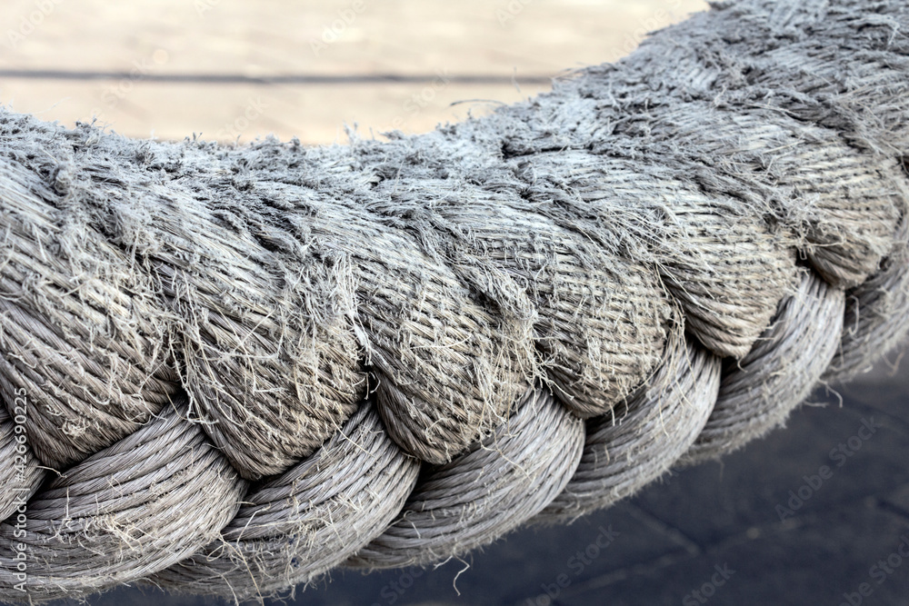 Close up of a strong rope hanging in the air, horizontally adividing ...