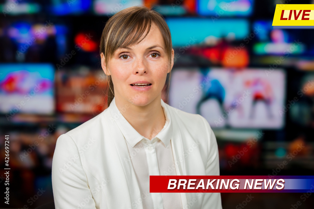 An anchorwoman reporting live breaking news sitting in Tv studio ...