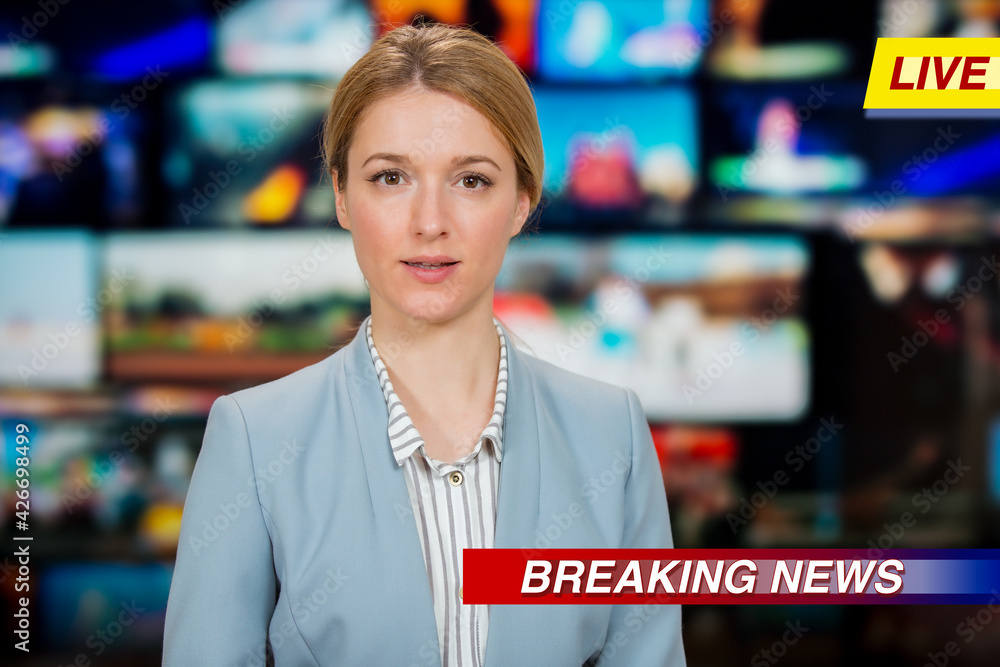 An anchorwoman reporting live breaking news sitting in Tv studio ...