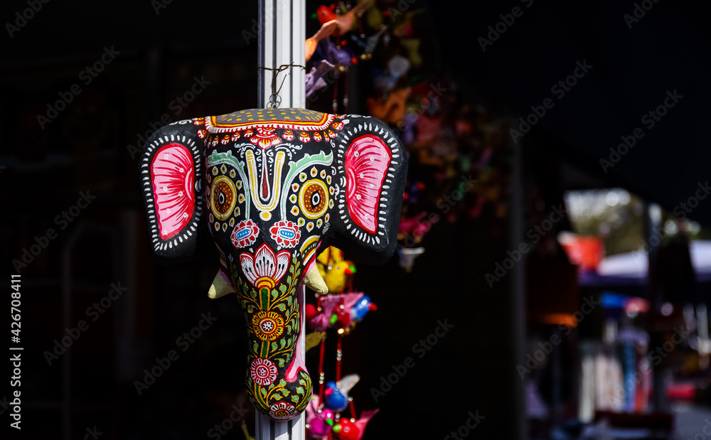 A colorful Lord Ganesha hand made mask for decoration with blur ...