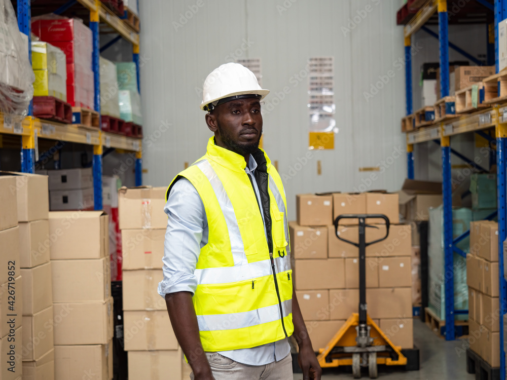 Portrait of African American male warehouse worker wearing a uniform ...