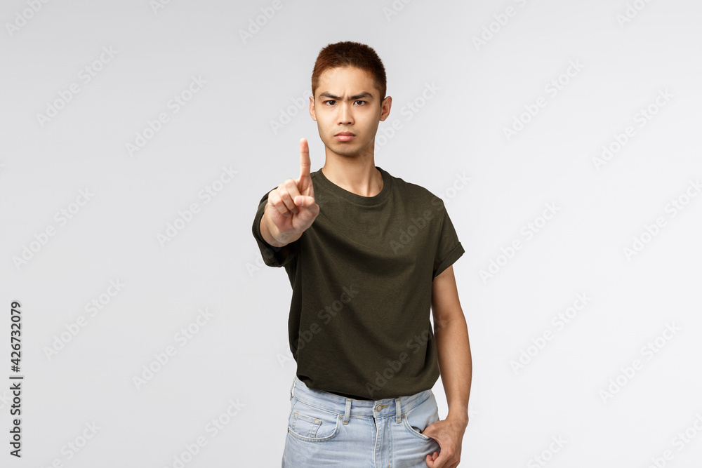 Portrait of strict and serious, angry asian man shaking finger ...